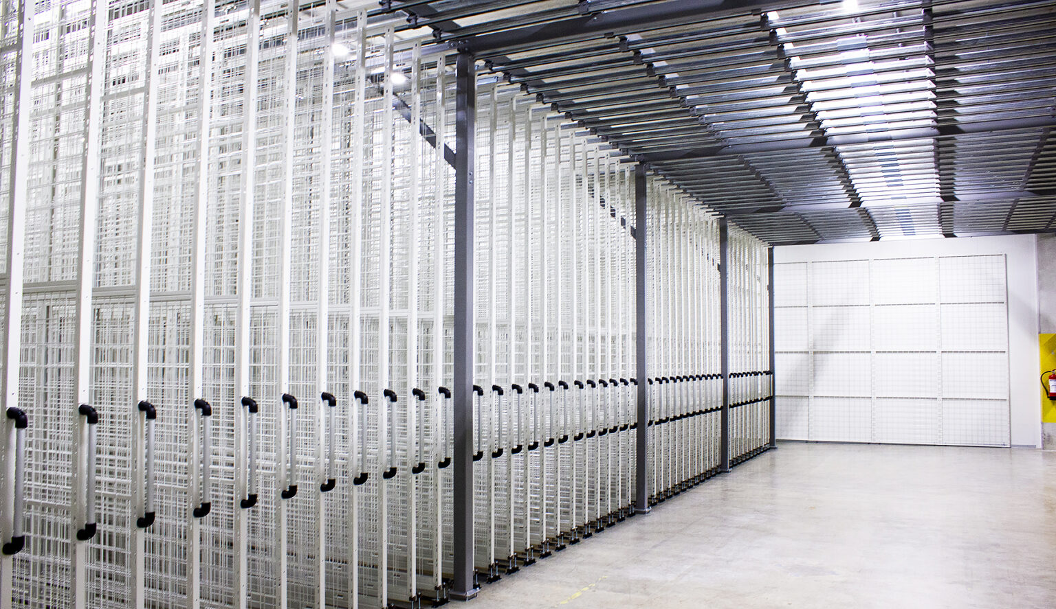 Sliding mesh walls with the 900 series for a huge art storage - Helaform